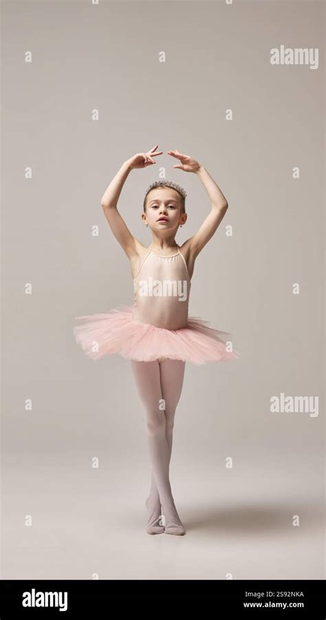 Girl Little Ballerina Wearing Tutu Standing In Classic Ballet Pose