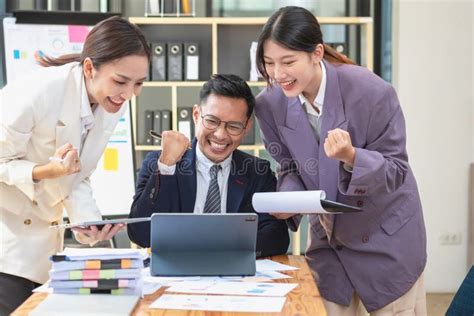Team Business Three Smiling And Happy Asian Men And Women Team Using