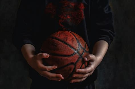 Premium Ai Image A Boy Holding A Basketball In His Hands