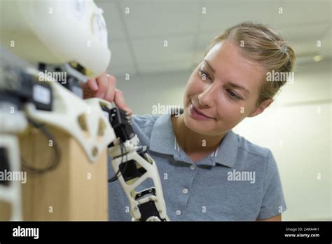 A Woman Fixing Robotic Arm Stock Photo Alamy
