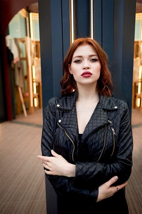 Portrait Of A Beautiful Redhead Fiery Hair And Full Lips Walking Around The City Stock Image