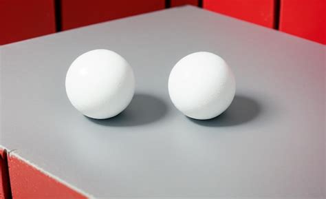 Premium Ai Image Contrasting Unity White Ball On Top Of Red Cube