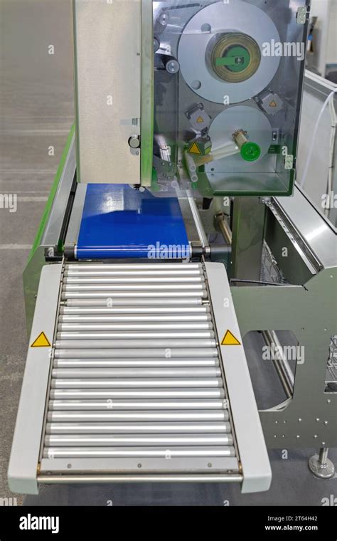 Conveyor Rollers At Labeler Machine Automated Production Line In