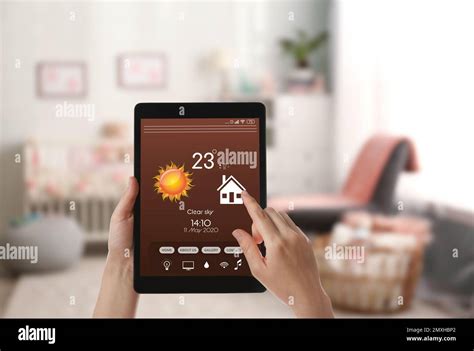Woman Using Tablet To Set Indoor Temperature Closeup Smart Home Automation System Stock Photo