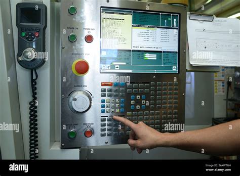 Worker Hands Touching The Button On The Board Of Computer Numerical Control Of The CNC Milling
