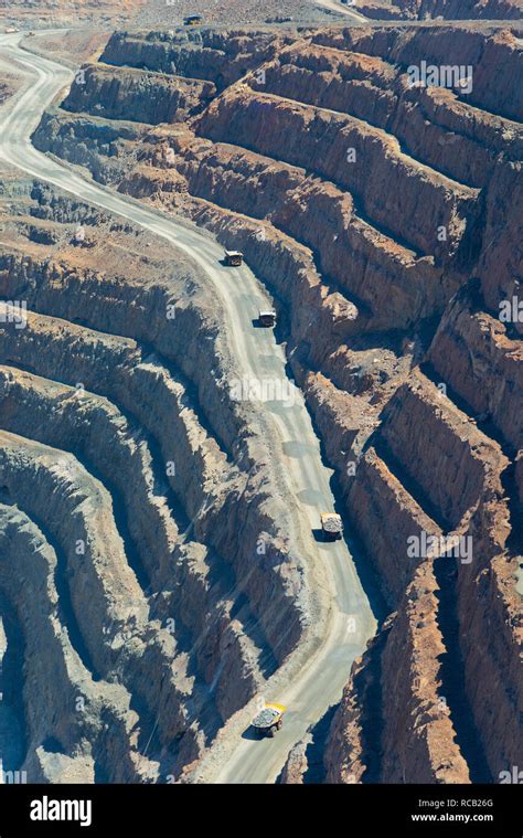 Dump Trucks Drive Along Haul Roads At The Fimiston Open Pit Mine Known