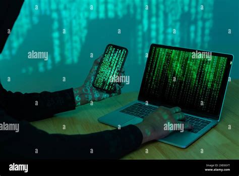 hacker using computer for organizing massive data breach attack on