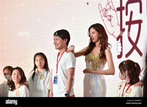 Taiwanese Model And Actress Lin Chi Ling Gives A Fan Massages During A