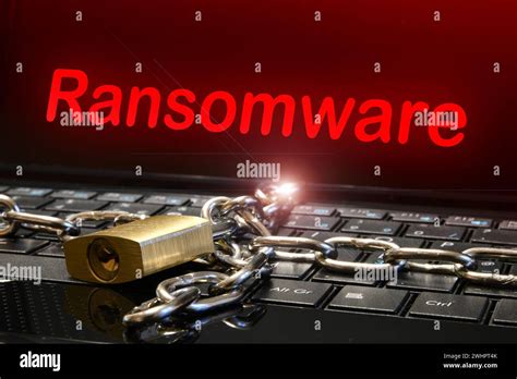 computer security concept with an iron chain and padlock on the laptop keyboard and ransomware