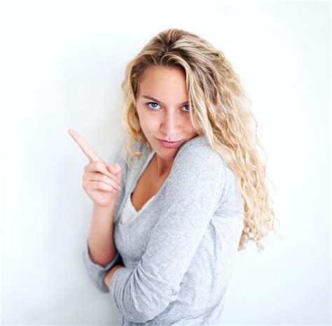 Premium Photo Woman Portrait And Pointing Finger Playful Or Flirt Fun White Wall Background As