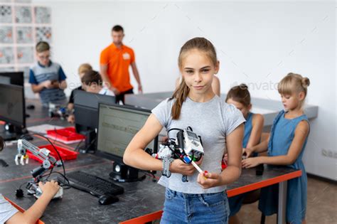 Portrait Of Female Student Building Robot Vehicle In After School