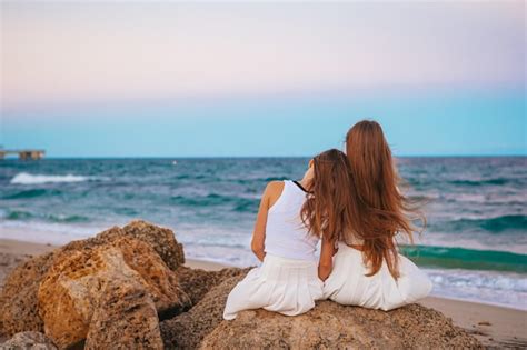 Adorable Teen Girls On The Beach At Sunset With Beautiful Colourful Sky