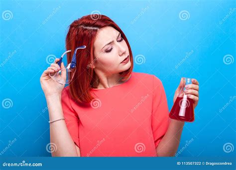 Confused Beautiful Nerd Girl With A Tube Of Red Liquid In Her Ha Stock Photo Image Of Medical