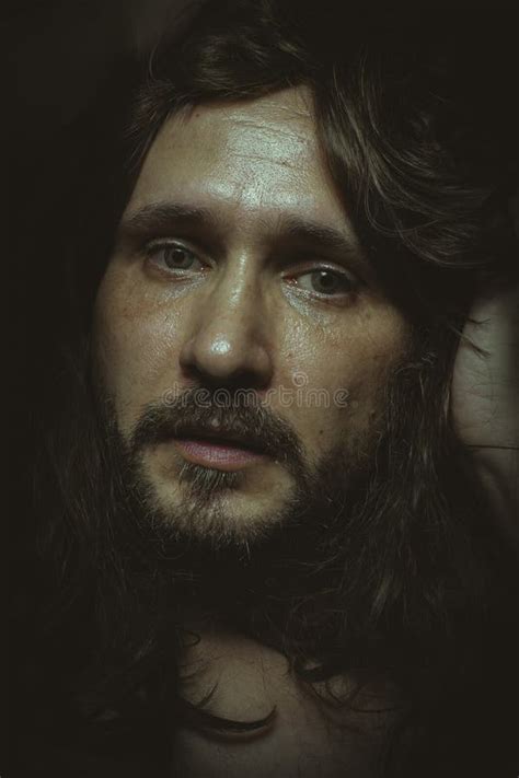 Religious Jesus Christ With Long Hair In The Foreground A Man Stock