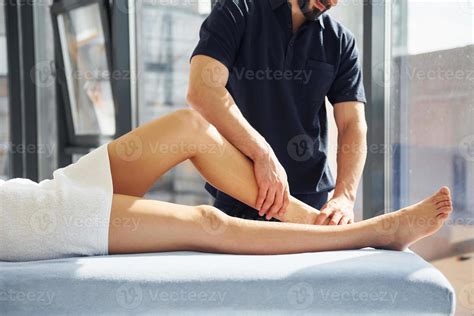 Guy Does Legs Massage Young Woman Is Lying Down When Man Serves Her At
