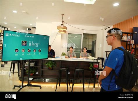 A Freshman Stands In Front Of A Face Recognition Machine To Register At The Campus Of Zhejiang A