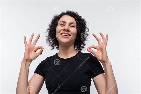 Joyful Brunette With Curly Hairstyle Wearing A Basic T Shirt Stock