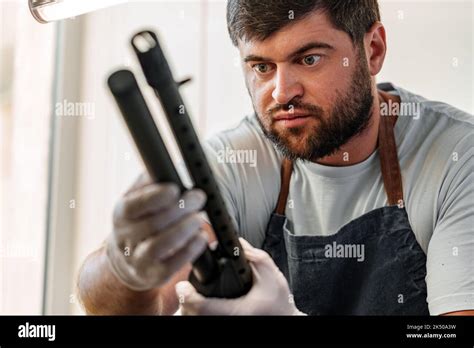 The Gunsmith Maintaining His Rifle In A Workshop Stock Photo Alamy