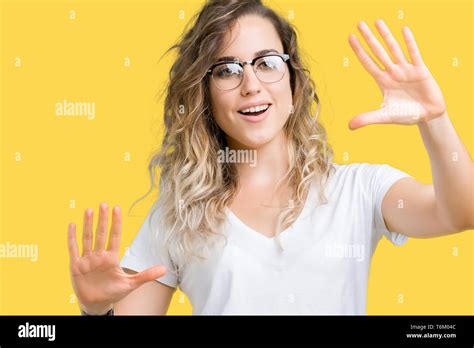 Beautiful Young Blonde Woman Wearing Glasses Over Isolated Background