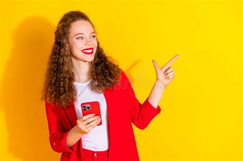 Portrait Of Gorgeous Young Lady Hold Phone Direct Finger Empty Space Wear Red Suit Isolated On