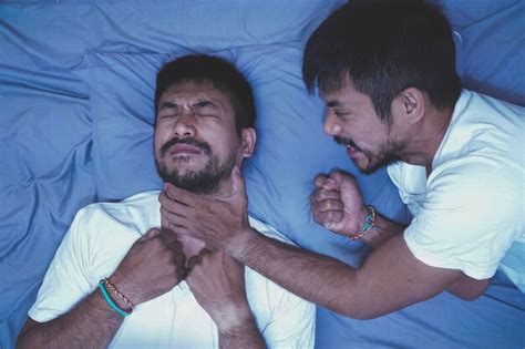 Premium Photo Cropped Hand Of Man Suffocating Twin Brother Sleeping On Bed