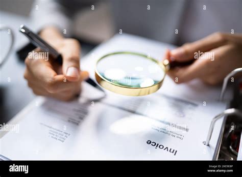 Auditor Using Magnifying Glass For Audit And Fraud Investigation Stock