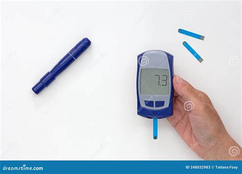 Hand Holding Glucometer With 73 Result On Display Royalty Free Stock