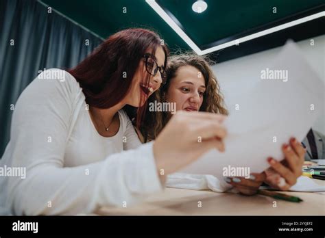 Two Babes Collaborating On Academic Work In A Classroom Setting Stock Photo Alamy