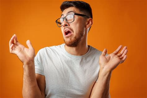 Premium Photo Portrait Of Young Nerd Man Shrugging Shoulders I Dont Know Gesture