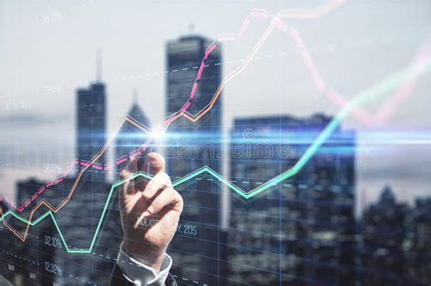 Close Up Of Businessman Hand With Pen Pointing At Creative Business Graph With Index And Grid On