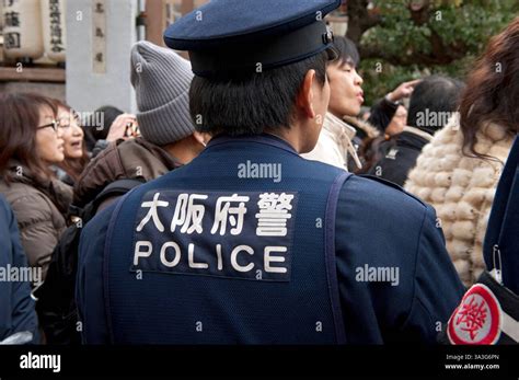 A Japanese Police Officer In Uniform From Osaka Prefectural Law