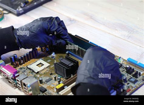 Inserting Ram Into Motherboard From Computer On Table And Gray