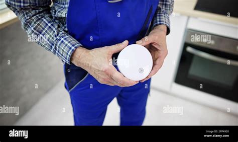 Electrician Holding Smoke Detector Fire Alarm Test And Installation Stock Photo Alamy