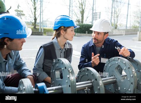 Men And Woman Monitoring Automation Robot Machine Stock Photo Alamy