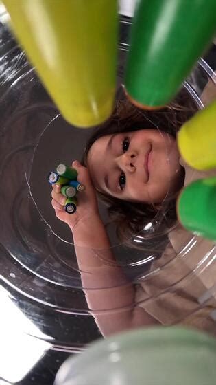 Vertical Pov Young Girl Throwing Batteries In Recycling Bin 50770213