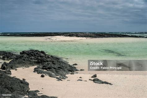 토스톤 등대 엘 코티요 푸에르테벤투라 근처 아름다운 풍경 카나리아 섬 스페인 이국적인 휴가에서 엽서 하얀 모래와 푸른 바다 물 구름과 하늘 라빅 검은 바위 0명에 대한 스톡