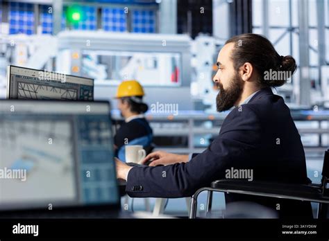 Photovoltaics Factory Engineer Looking At Pc Screen Adjusting System Parameters Technician