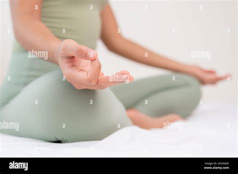 Woman Practicing Meditation On The Bed Doing Yoga Breathing With Ardha