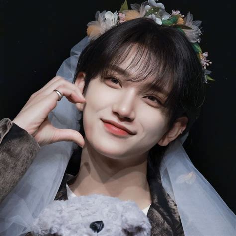 A Young Man Wearing A Veil And Flower Crown