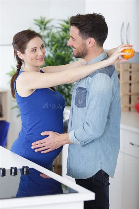 Husband Hugs Pregnant Wife In Kitchen Stock Image Image Of Relaxing