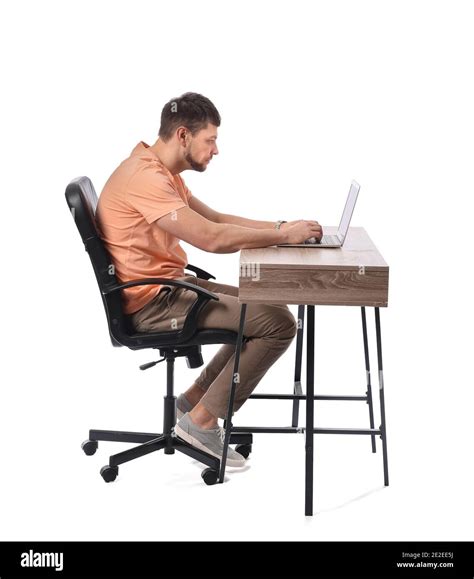 Man With Bad Posture Using Laptop While Sitting At Table On White