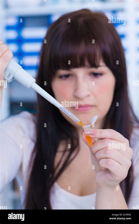 MODEL RELEASED Female Lab Technician Using A Pipette Stock Photo Alamy