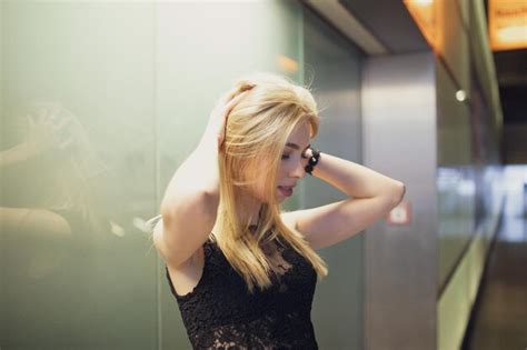 Premium Photo Beautiful Young Woman Standing Against Glass Window