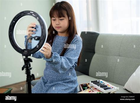 An Adorable Young Asian Girl Recording Her Video Or Live Streaming