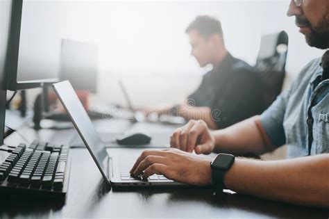 portrait of two professional male programmers working on computer in