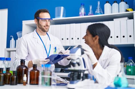 Man And Woman Scientists Using Microscope Working At Laboratory Stock Image Image Of Biology