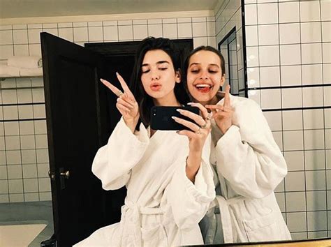 Two Women Taking Selfie In Front Of Mirror