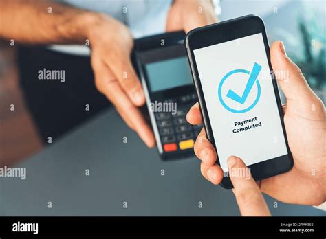 Hand Holding Smartphone With NFC QR Code Device Scanning Contactless Payment Code For Fast