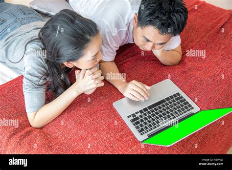 Couples Using Laptop Bedroom Stock Photo Alamy