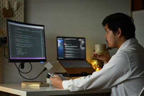 Premium Photo Bearded Male Software Developer Drinking Coffee And Coding At Home Office